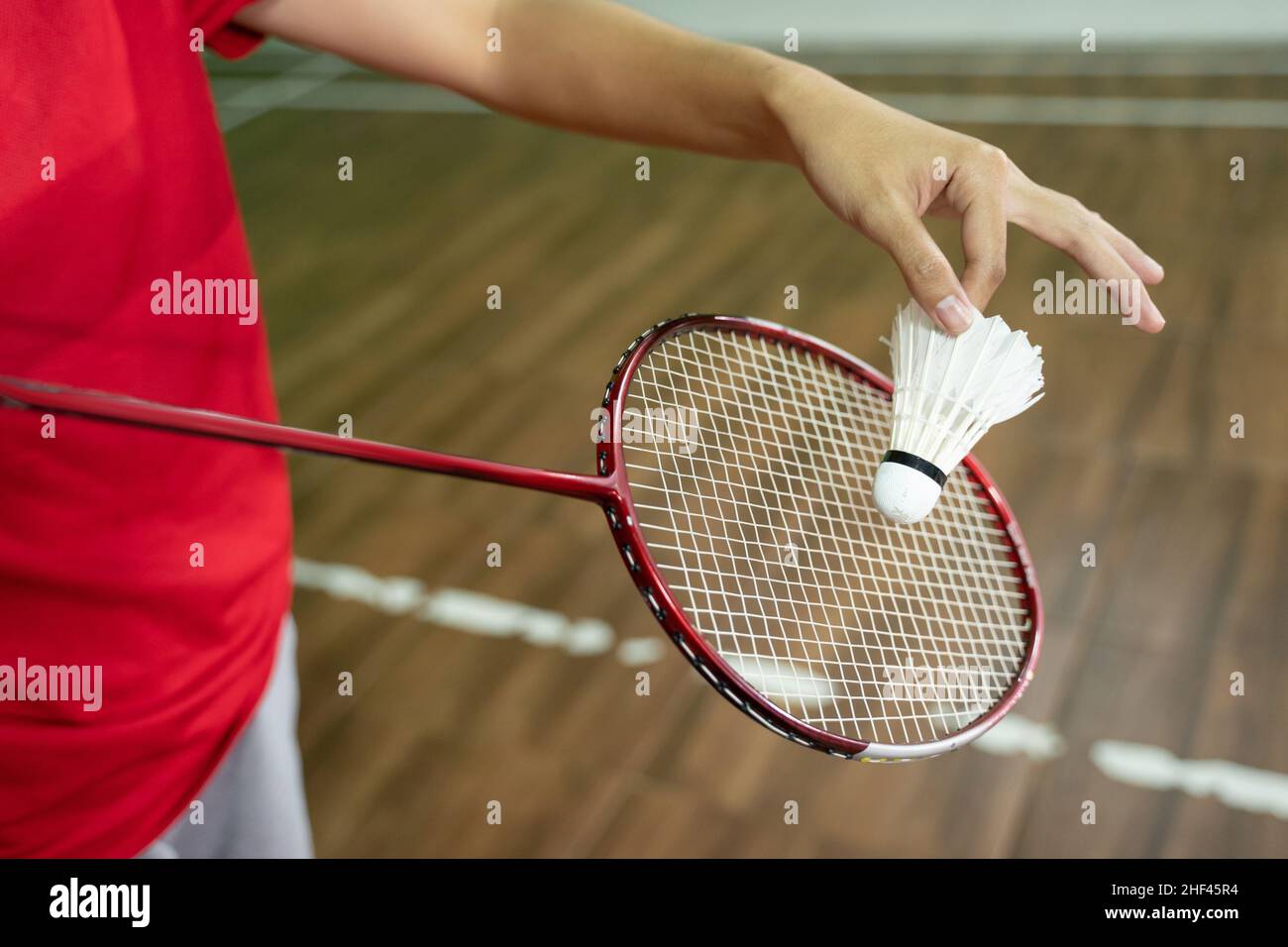 Close up of badminton player's hand holding racket and shuttlecock ...