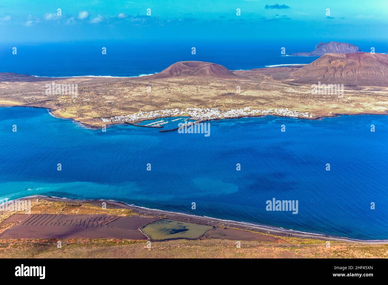 The Island of La Graciosa and the port of Caleta del Sebo taken from ...