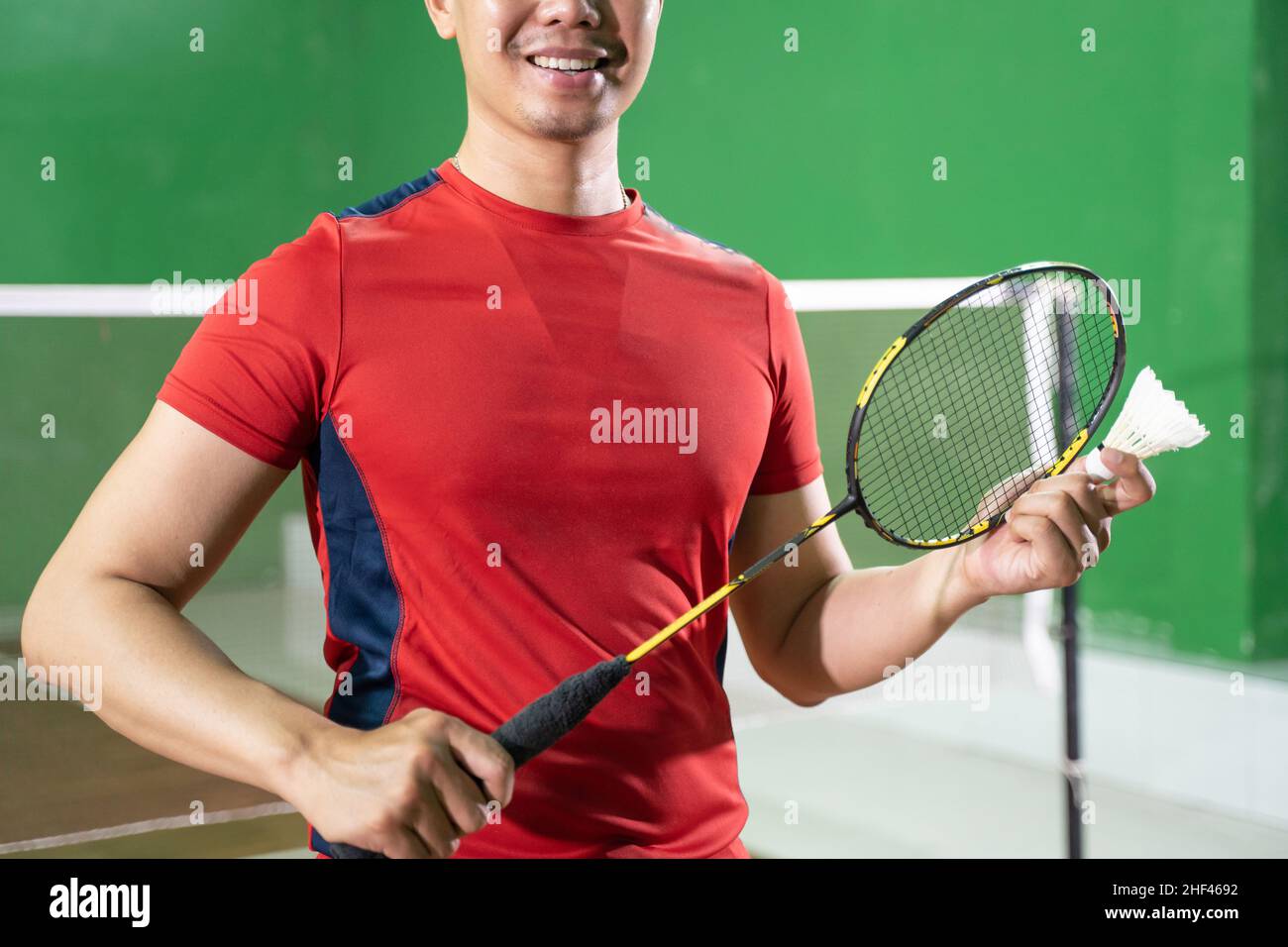 player's hand holding racket and shuttle on indoor court Stock Photo ...