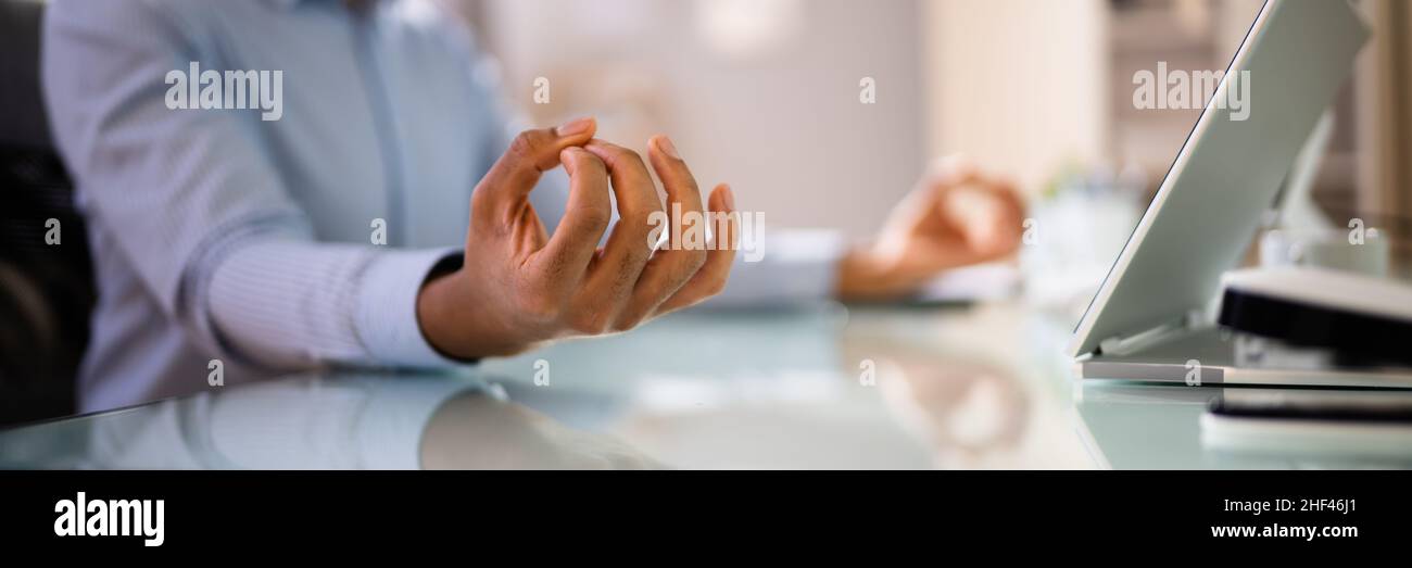 African American Male Meditation In Office Near Computer Stock Photo ...
