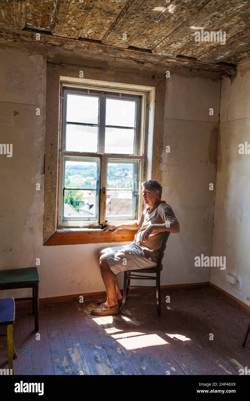 man sitting at the window of an old house in weimar Stock Photo - Alamy