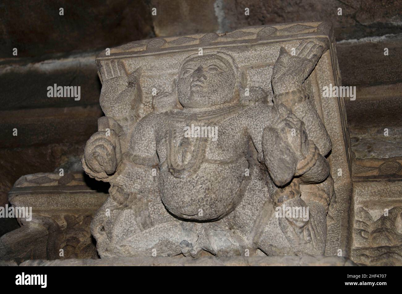 Carved Dwarf holding pillar on the inner wall of Kukdeshwar Temple ...