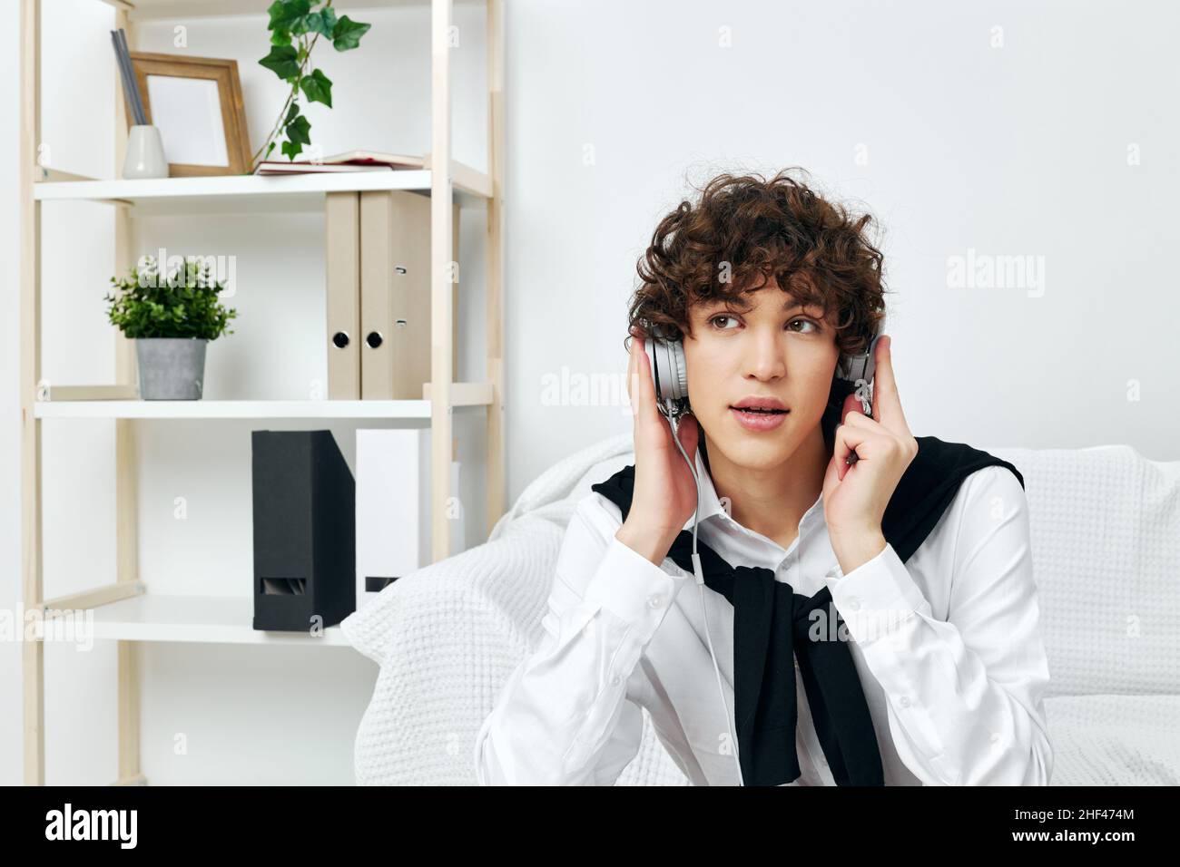 guy doing homework with headphones at the table living room Stock Photo ...