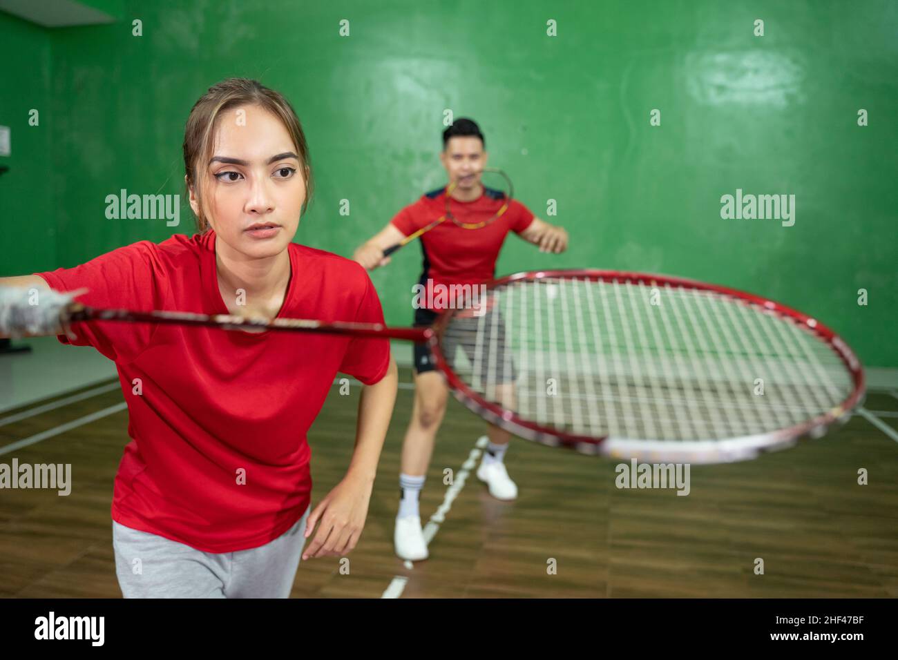 Beautiful badminton player ready to receive shuttlecock with her ...