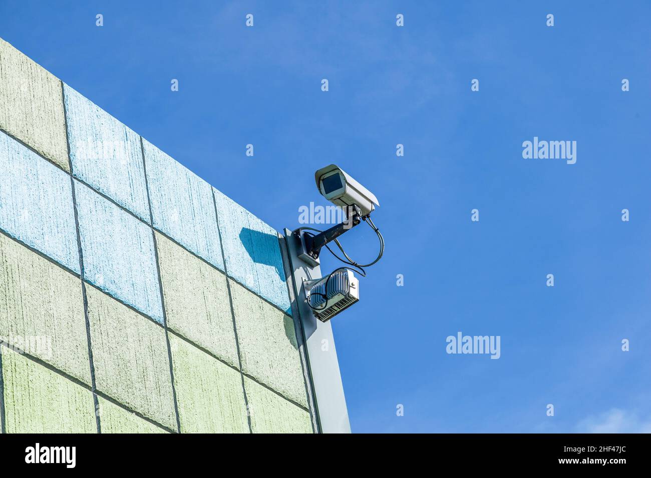 observation camera at a wall with blue sky background Stock Photo - Alamy