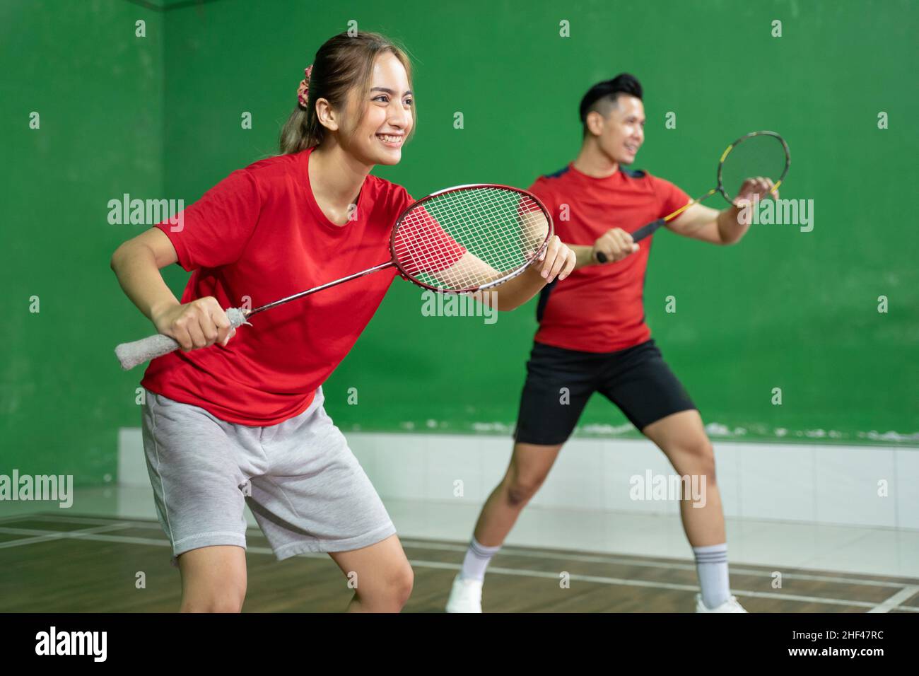 Beautiful female badminton player smiling with a ready stance Stock ...