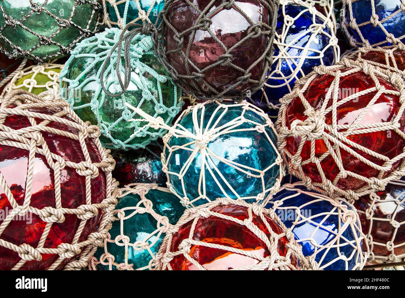 colorful balls of glass with rope Stock Photo - Alamy