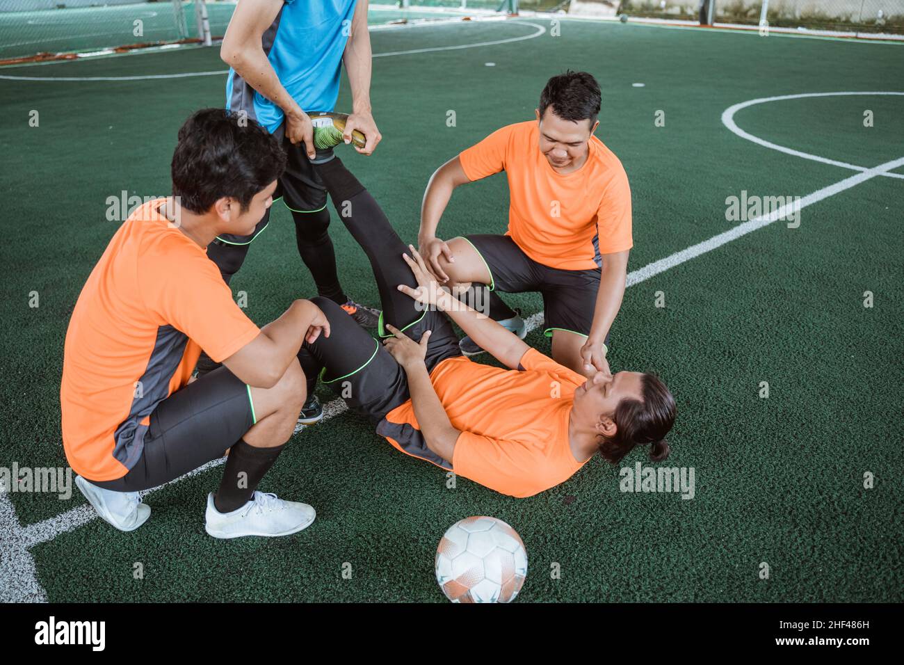 futsal player injured leg cramps helped by other players Stock Photo ...