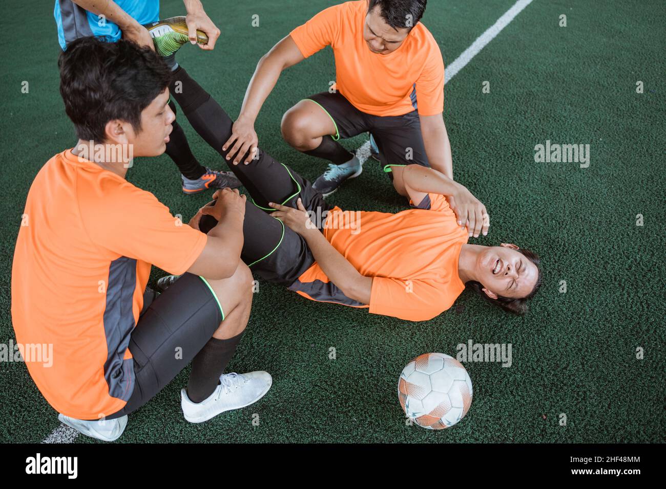Futsal players are in pain when they get leg cramps Stock Photo - Alamy