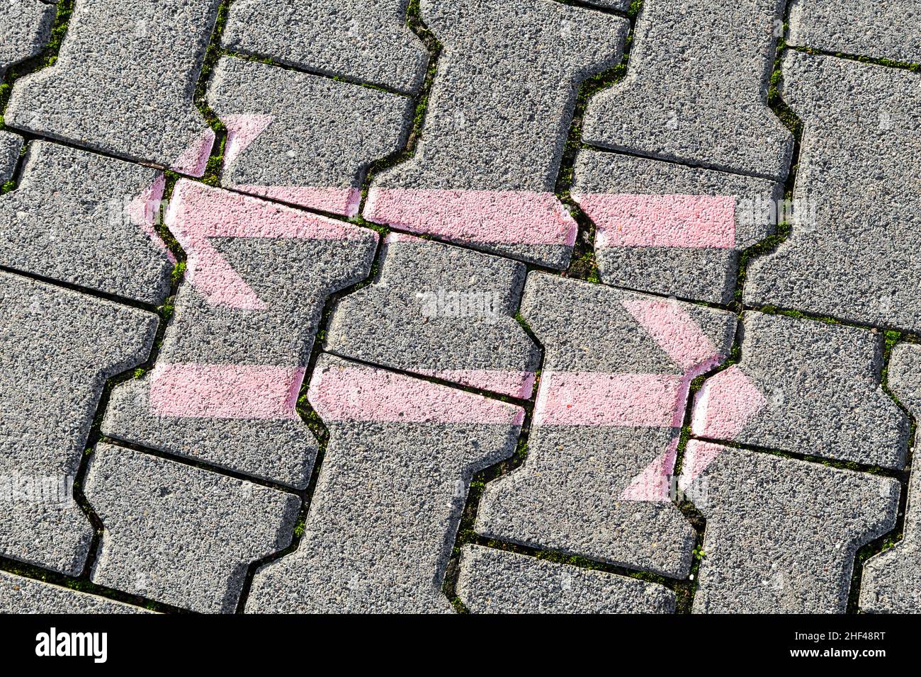 arrows on grey tiles of the sideway Stock Photo - Alamy
