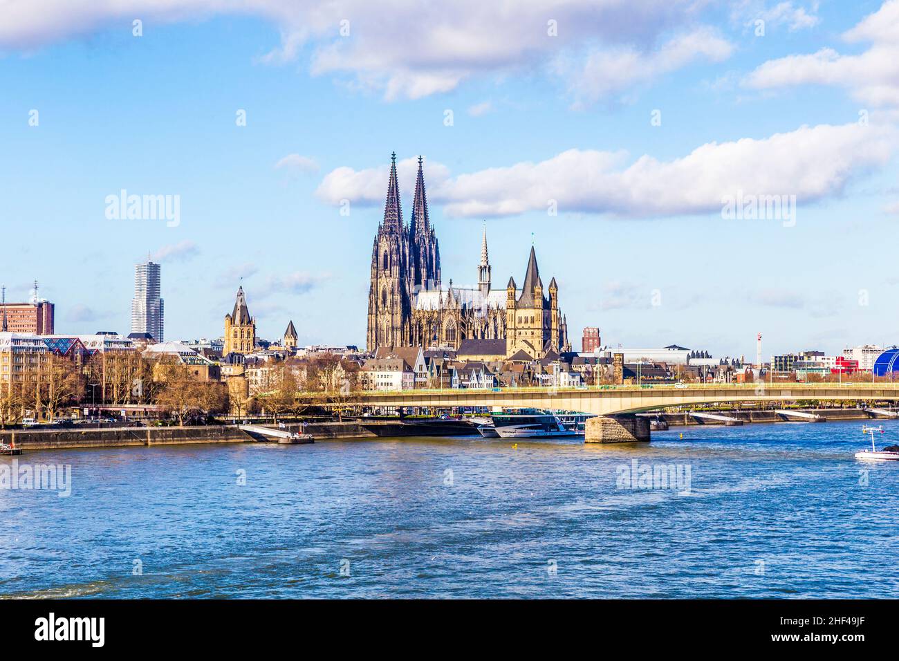 Cologne skyline with dome and bridge under blue sky Stock Photo - Alamy