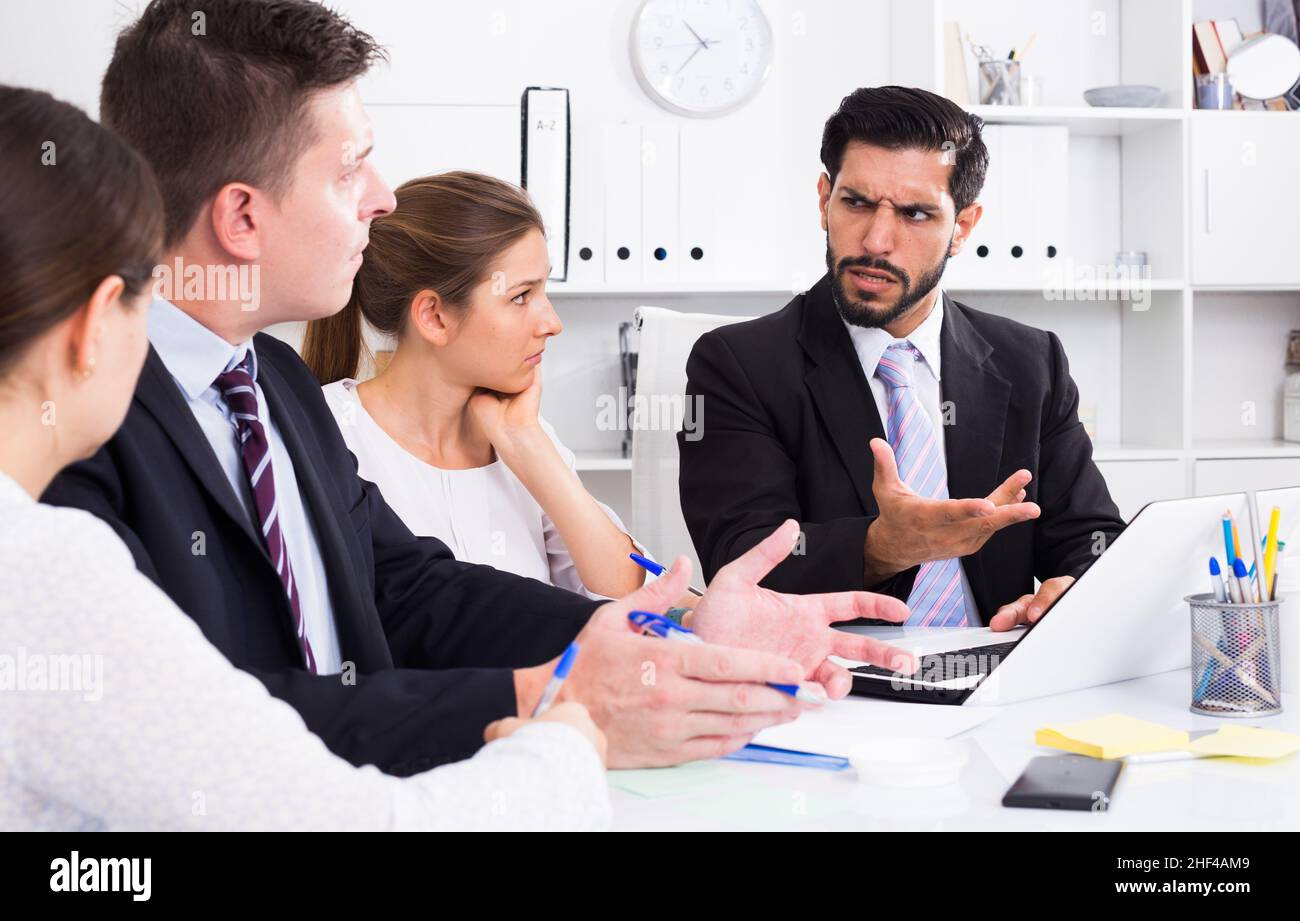 Outraged manager with colleagues at meeting Stock Photo - Alamy