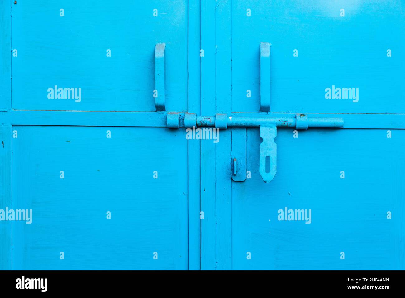 outdoor view at blue iron gate Stock Photo - Alamy