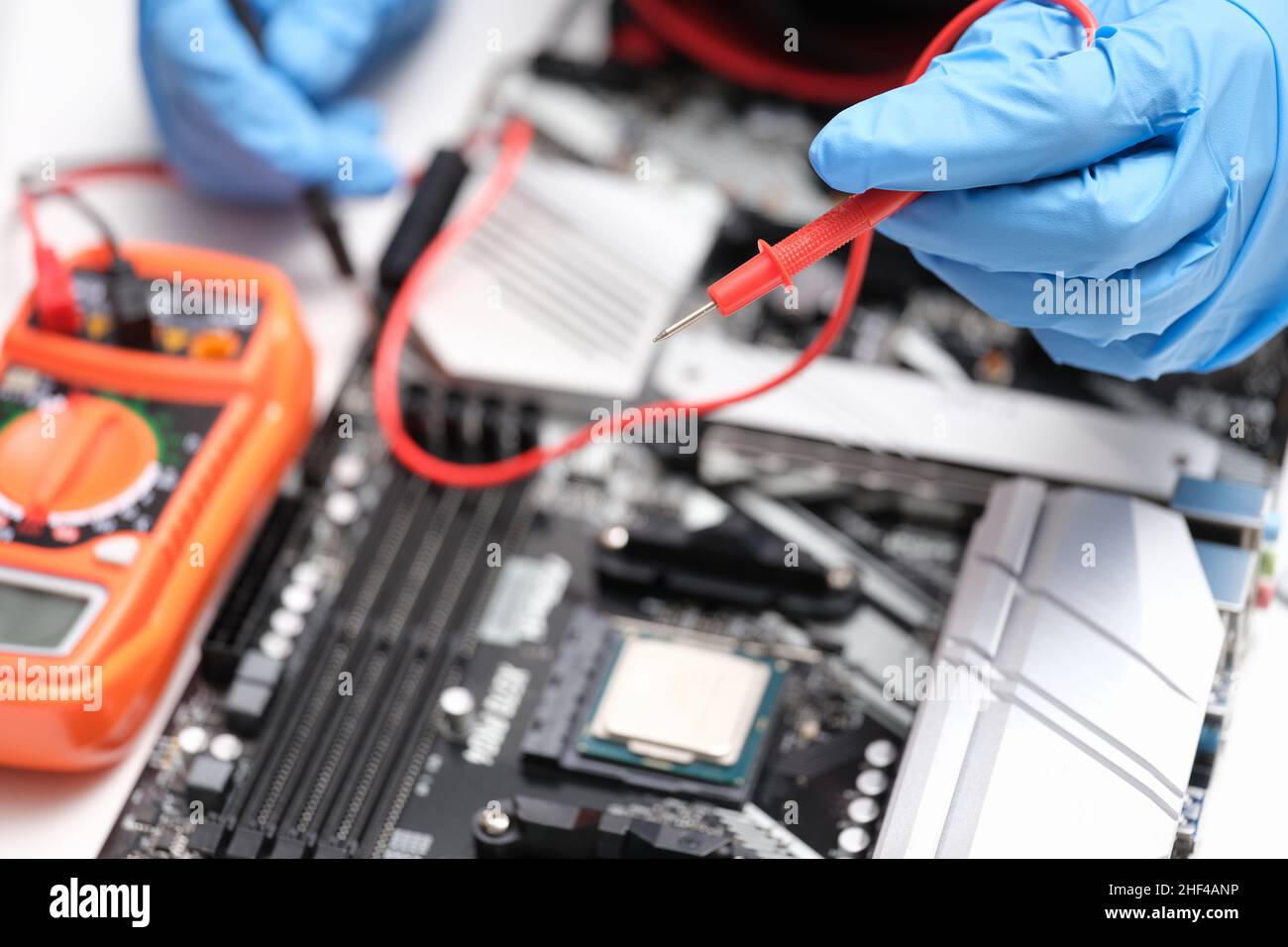 Hands with a multimeter to check electronic equipment Stock Photo - Alamy
