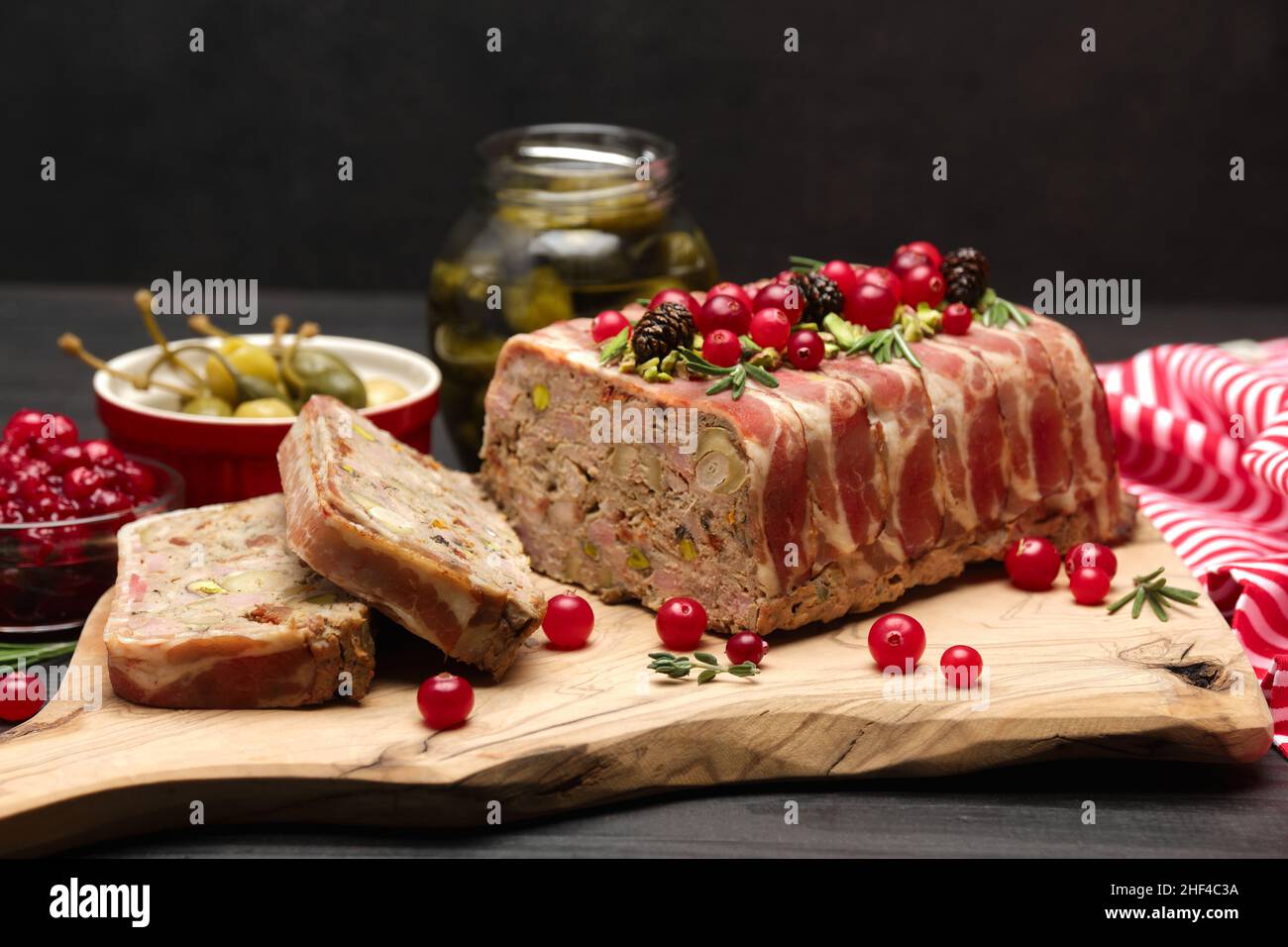 Traditional French terrine covered with bacon on dark wooden background ...