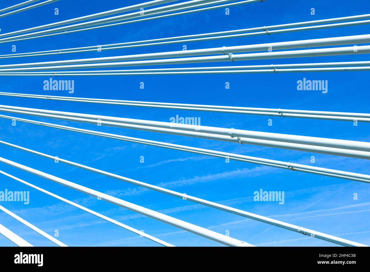 pattern of steel wires of a bridge under blue sky Stock Photo - Alamy