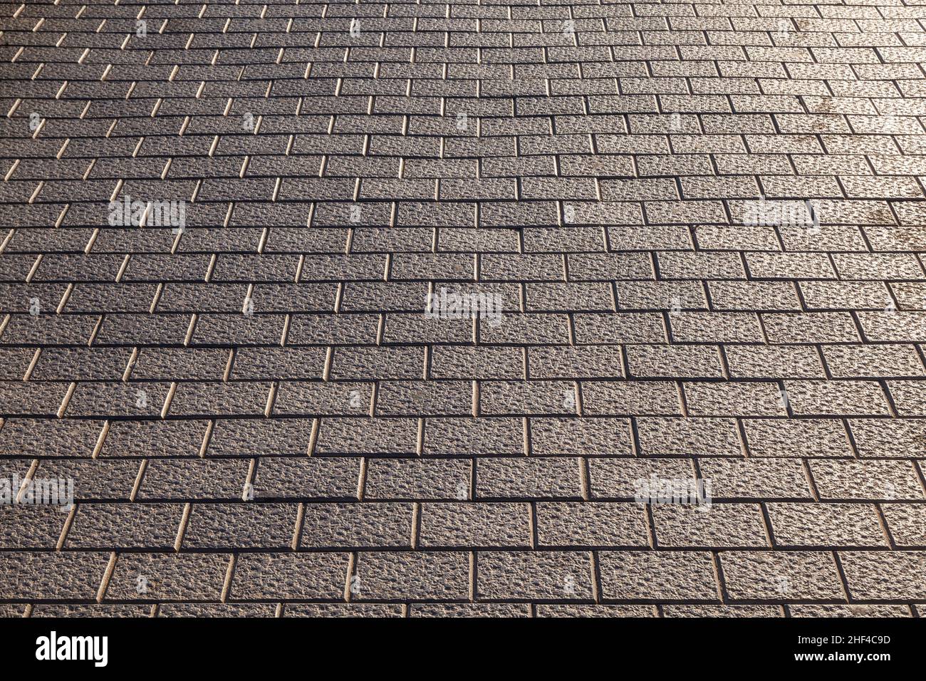 textured floor tiles with bright sun reflections Stock Photo - Alamy