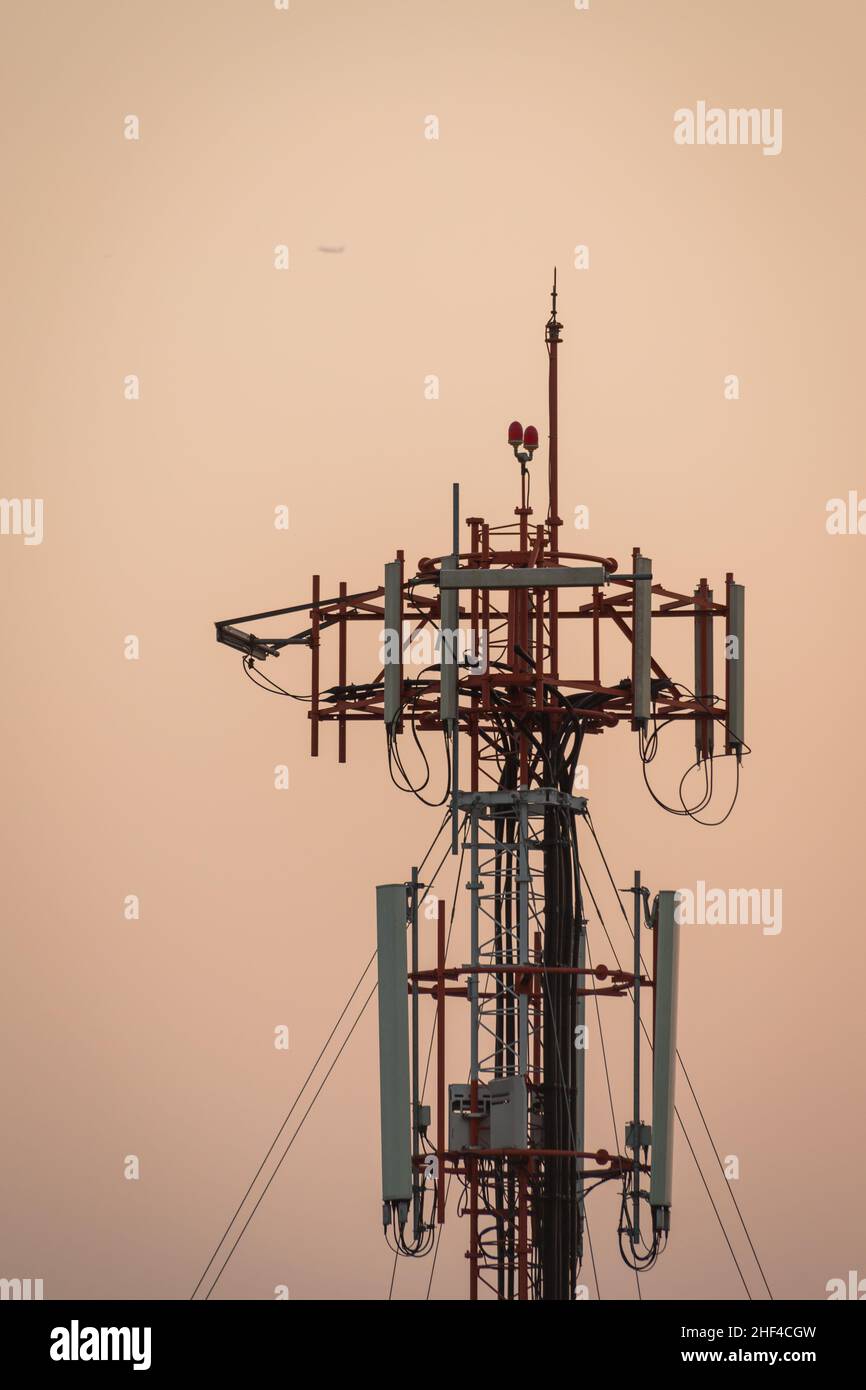 Telecommunications tower on sun set time Stock Photo - Alamy
