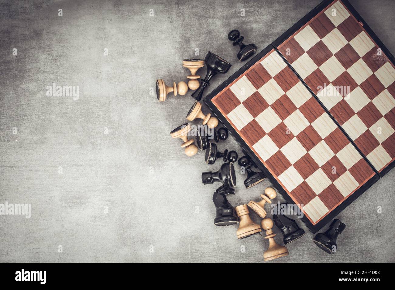 Chessboard and scattered chess pieces, top view Stock Photo - Alamy