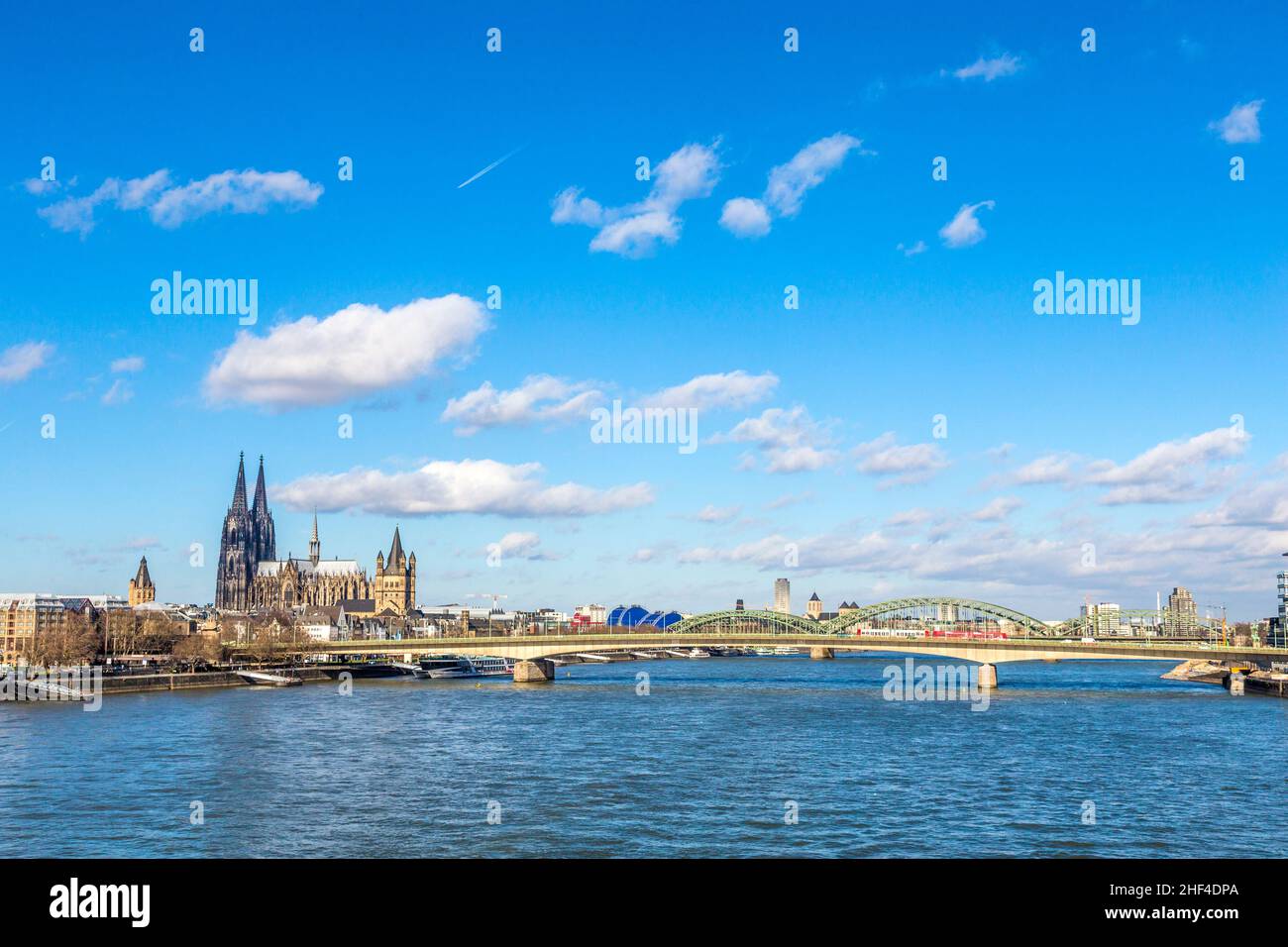 Cologne skyline with dome and bridge under blue sky Stock Photo - Alamy