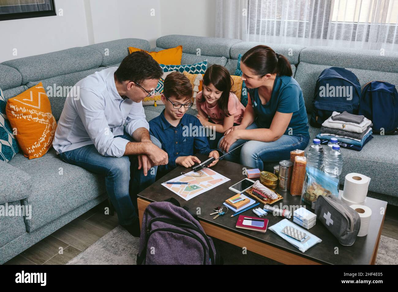 Parents explaining to their children how to use the radio in an ...