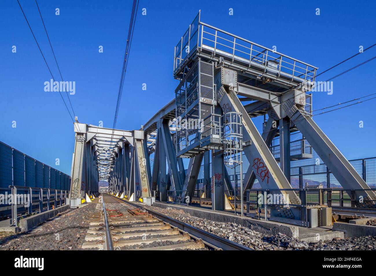 Modern railway steel bridge over highway. Tunnel inside the railway ...