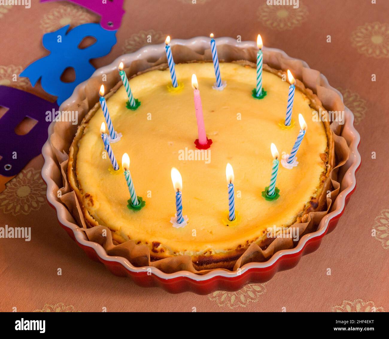 birthday cake with lots of candles at the table Stock Photo - Alamy