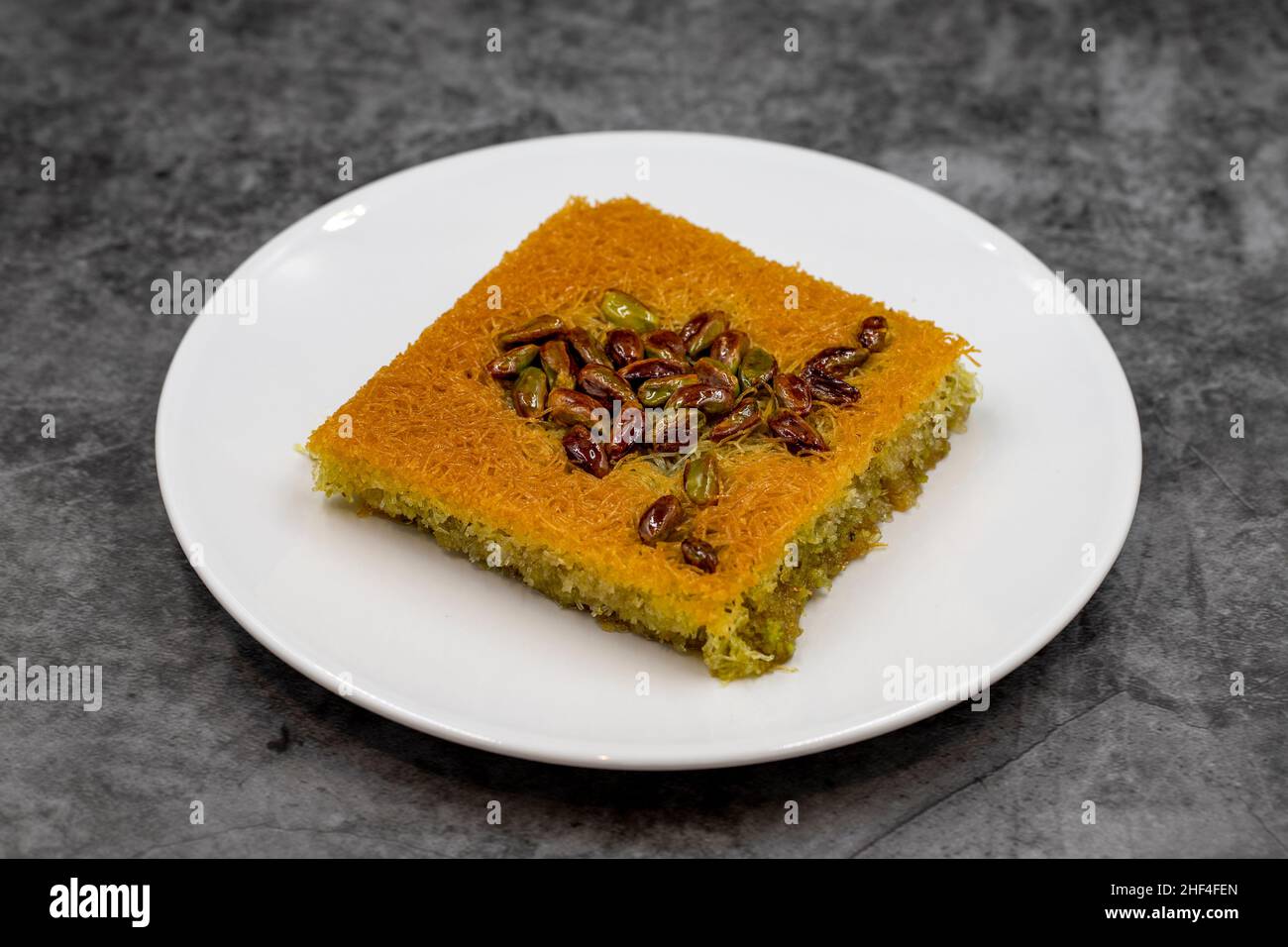 Pistachio kadayif dessert on dark background. Traditional Turkish ...