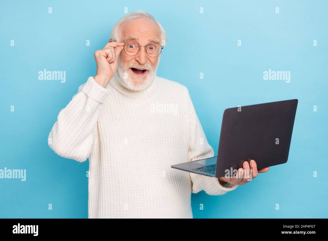 Photo of impressed old beard man look laptop wear eyewear sweater ...