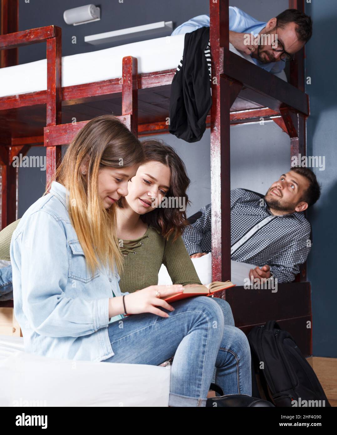 Two girls reading book Stock Photo - Alamy