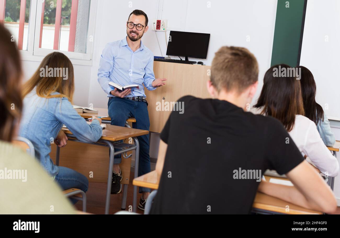 Man teacher giving lecture in classroom Stock Photo - Alamy
