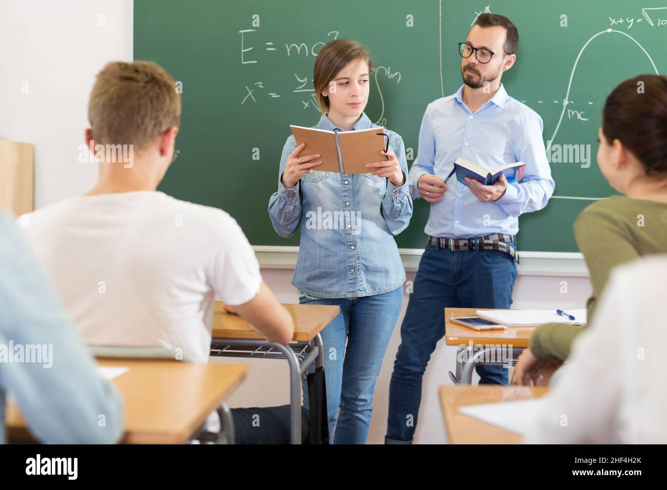 schoolgirl answer about task in the classroom Stock Photo - Alamy
