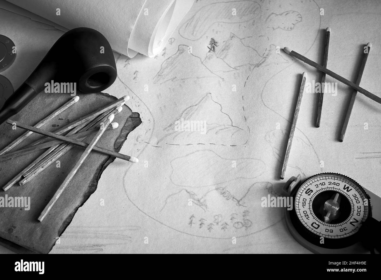 Black and white picture of adventurer desk with treasure map and ...
