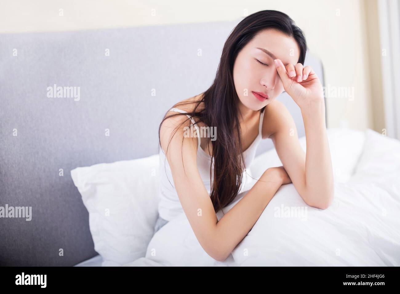 Beautiful young woman getting up Stock Photo - Alamy