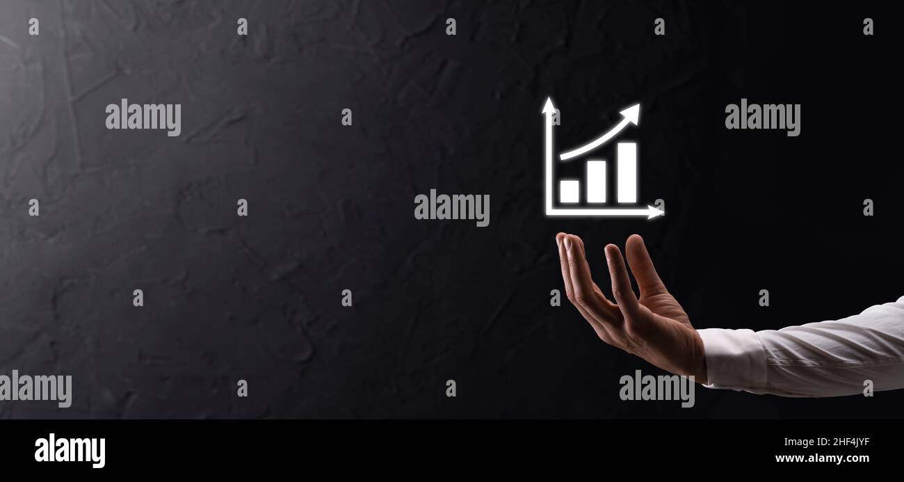 Businessman man holding a graph with positive profits growth. plan ...