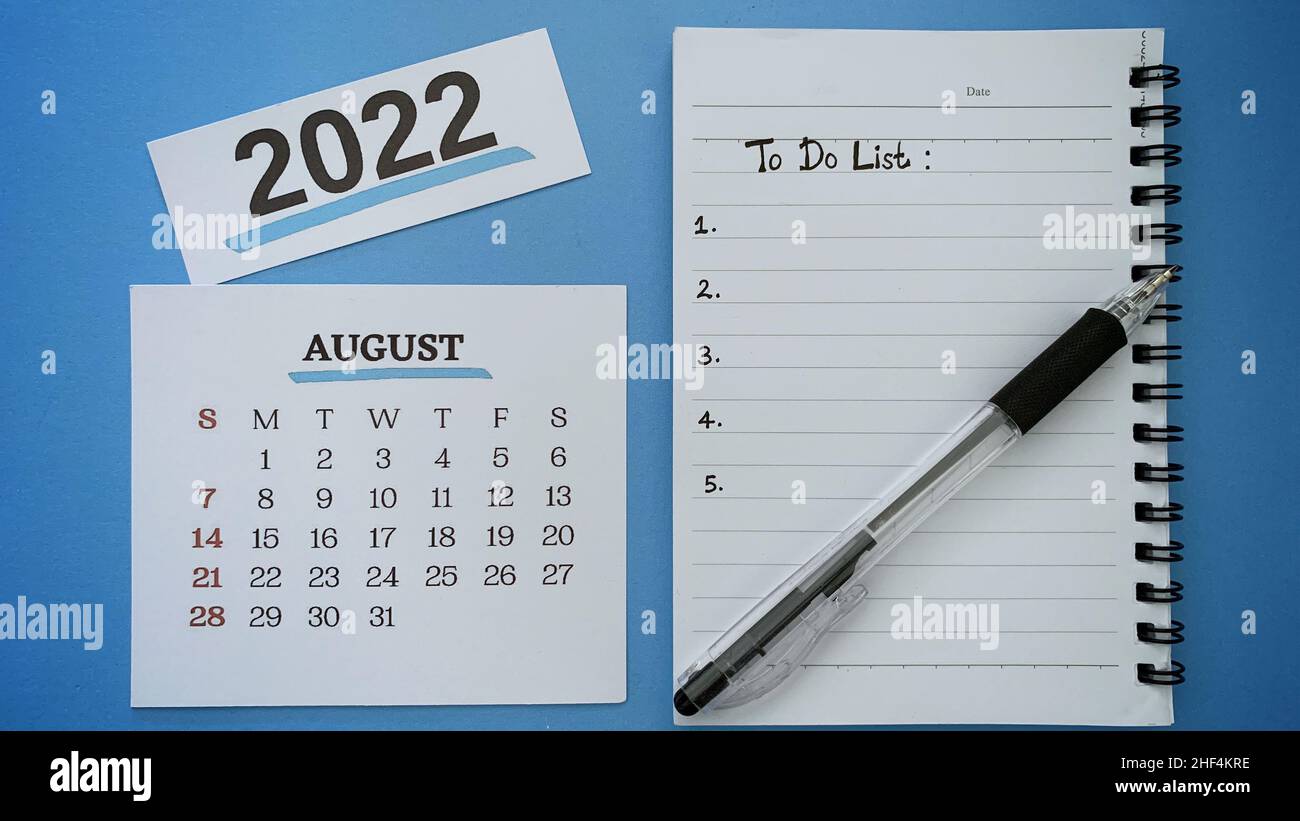 Hand written to do list text on note book for August month with pen and ...