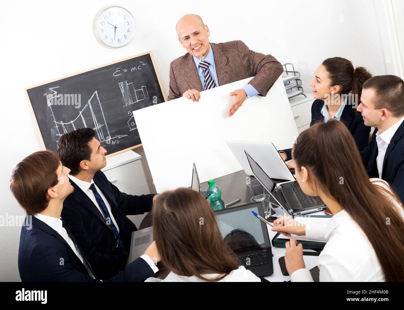 Businessman presents new development plan at poster Stock Photo - Alamy