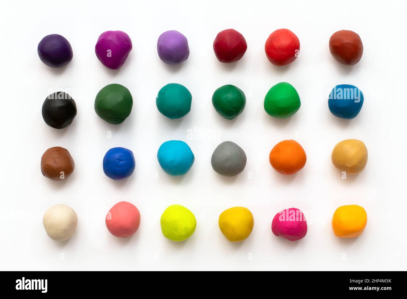 Pieces or balls of Colorful plasticine modelling clay isolated on white ...