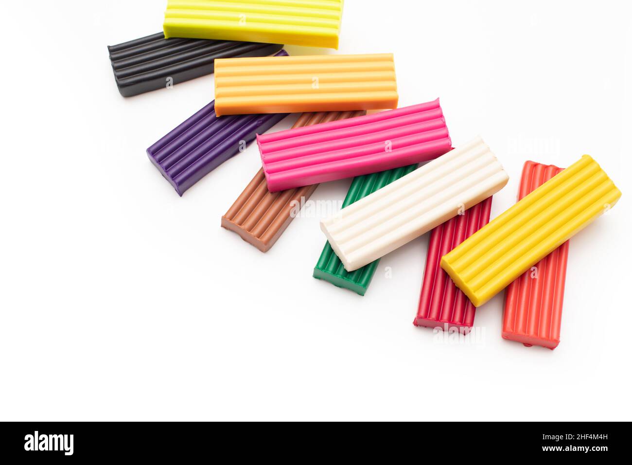 colored plasticine modelling clay pieces or sticks on isolated white ...