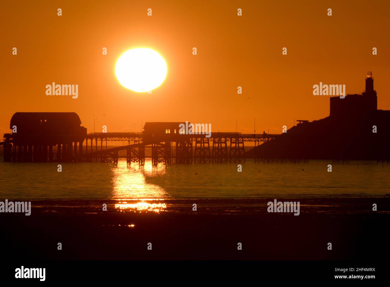 Sunrise over Mumbles Pier and Lighthouse Stock Photo - Alamy