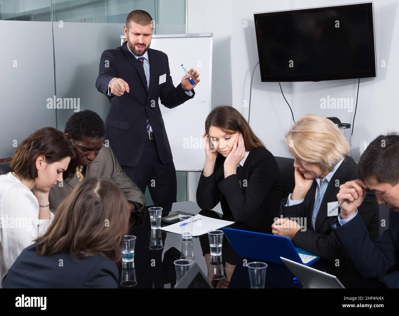 Angry boss berating his subordinates pointing out shortcomings Stock ...