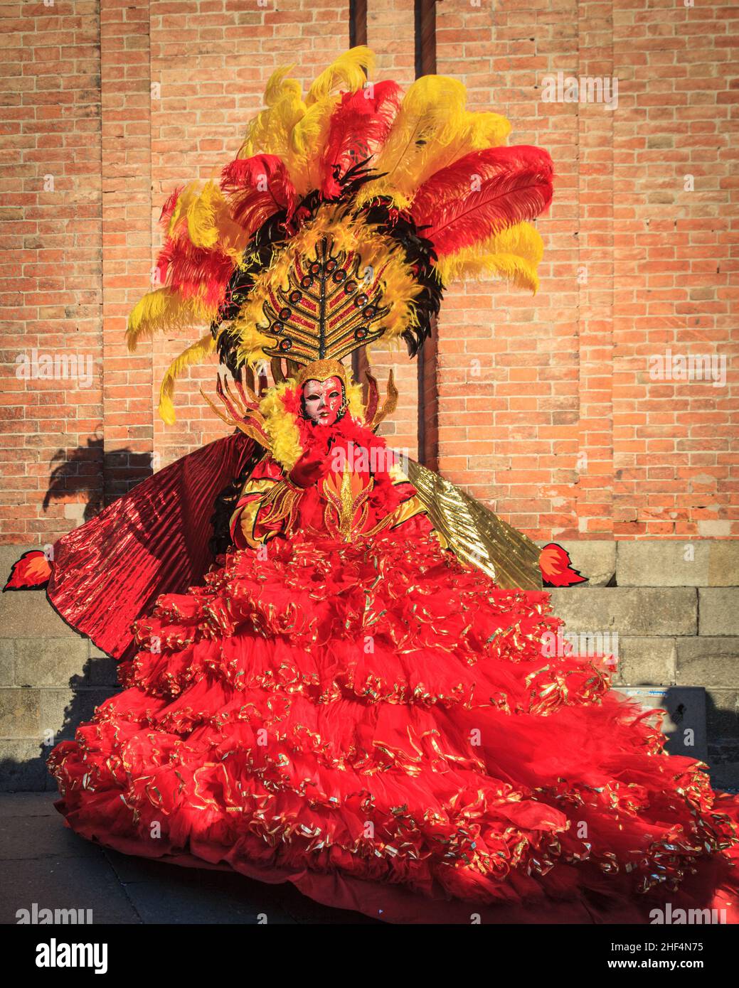 Woman in beautiful vibrant red, feathered historic Phoenix fancy dress ...