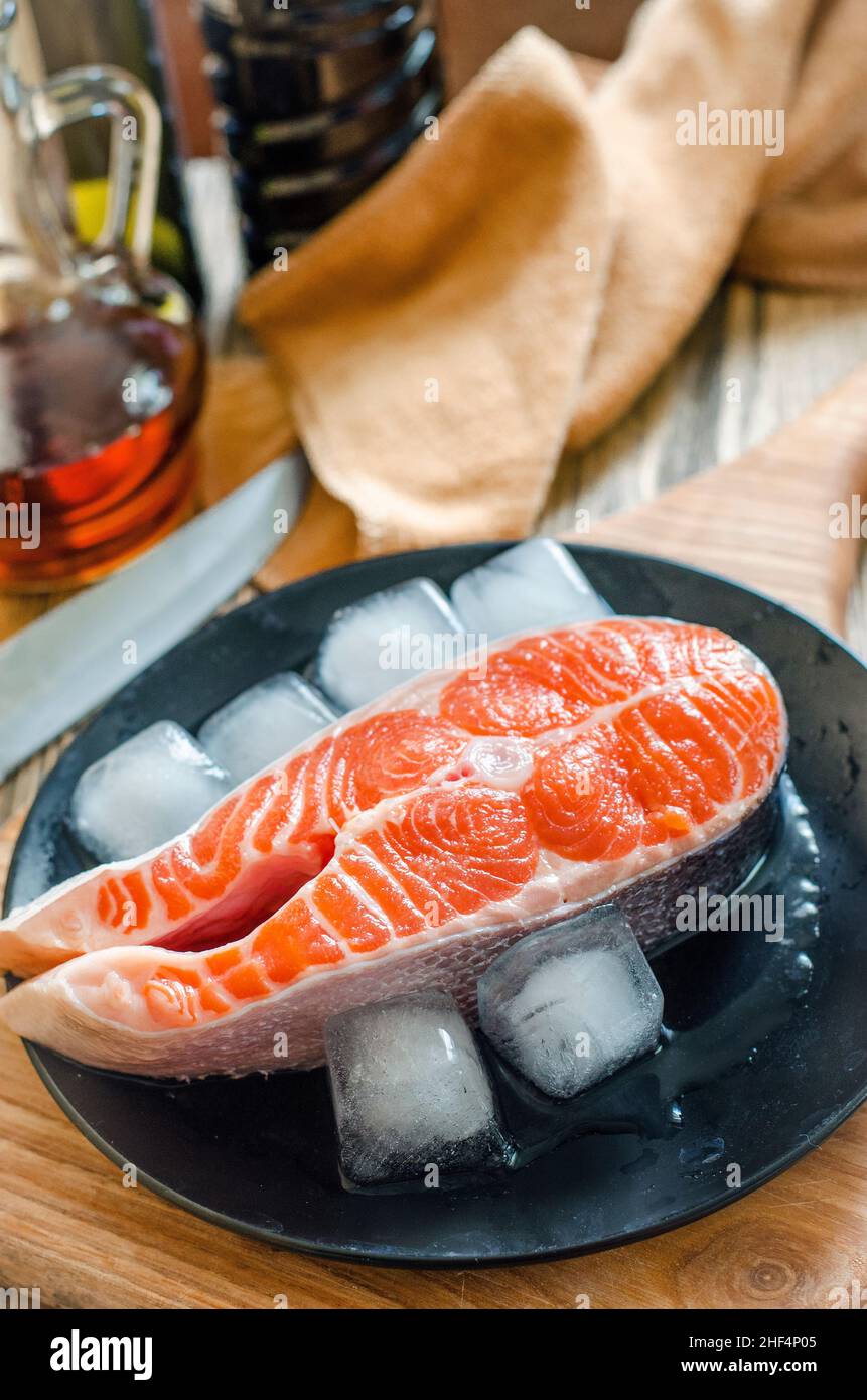 Raw salmon steak on the kitchen table Stock Photo - Alamy