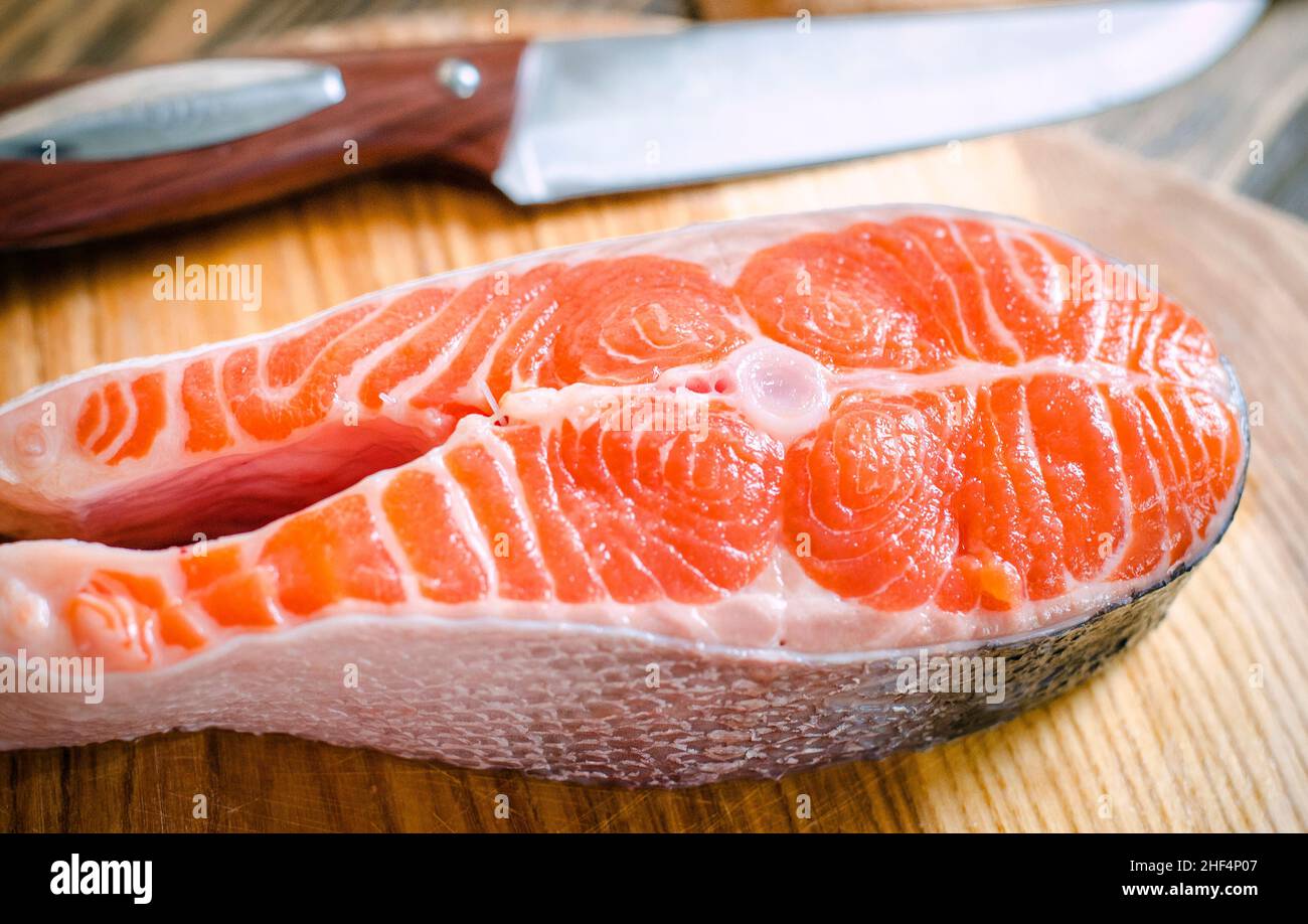 Raw salmon steak on the kitchen table Stock Photo - Alamy