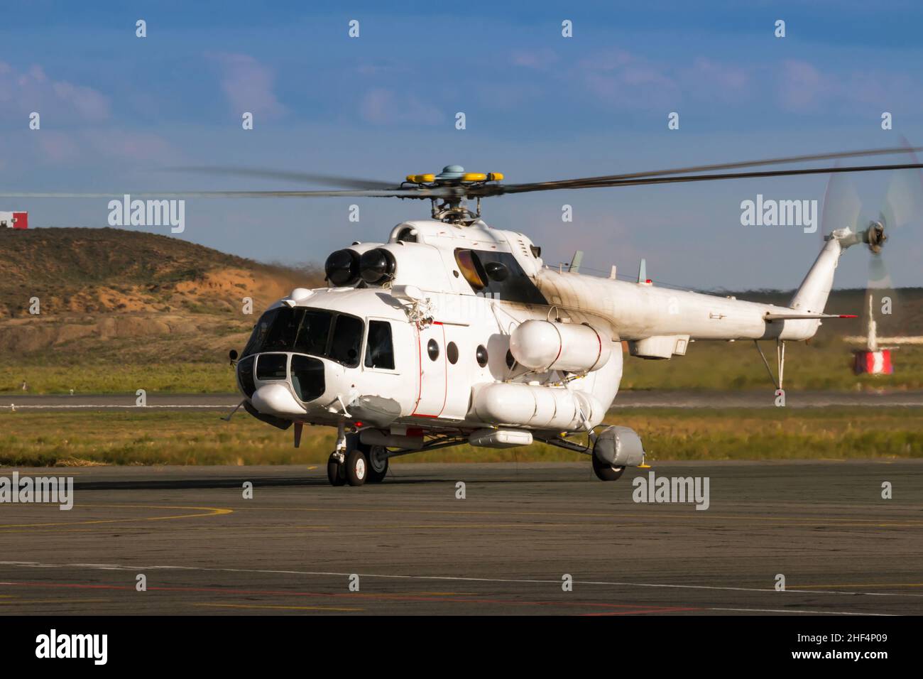 Taxiing a white passenger helicopter on the airport apron Stock Photo ...
