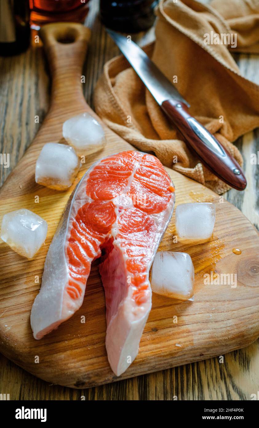 Raw salmon steak on the kitchen table Stock Photo - Alamy