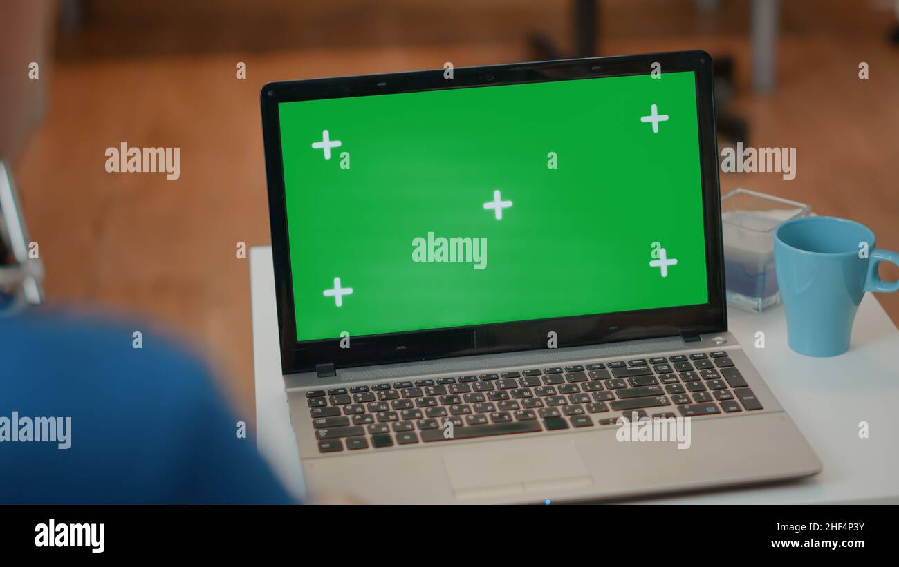 Senior man and woman looking at green screen on laptop. Elderly couple ...