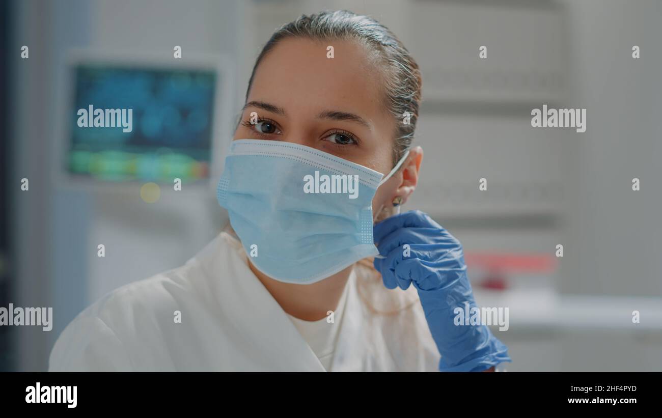 Portrait of biologist removing face mask before working in laboratory ...