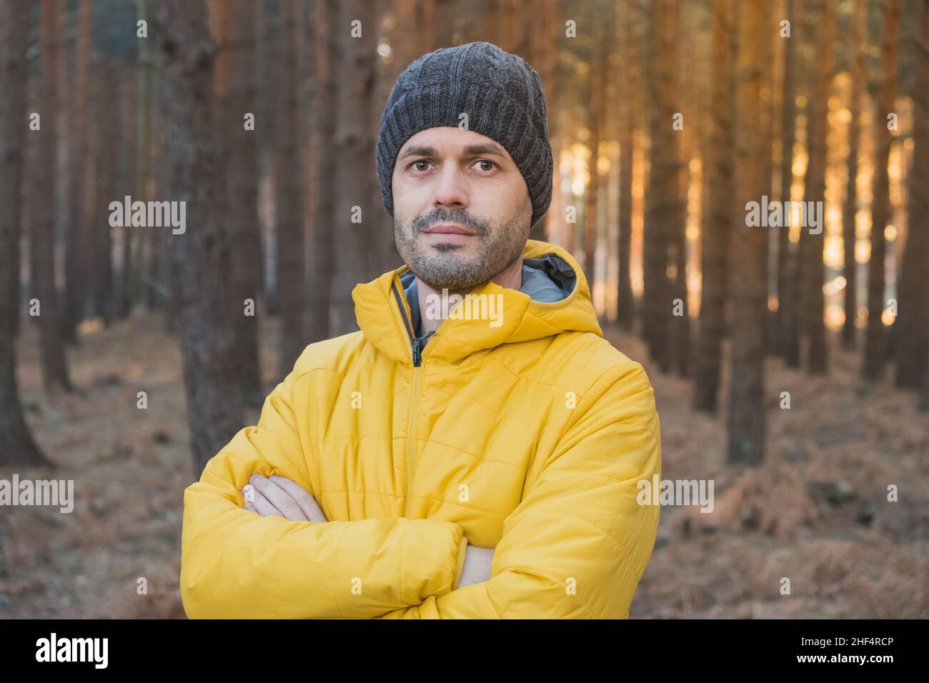 A man enjoys nature in the forest in winter. People explorer and ...