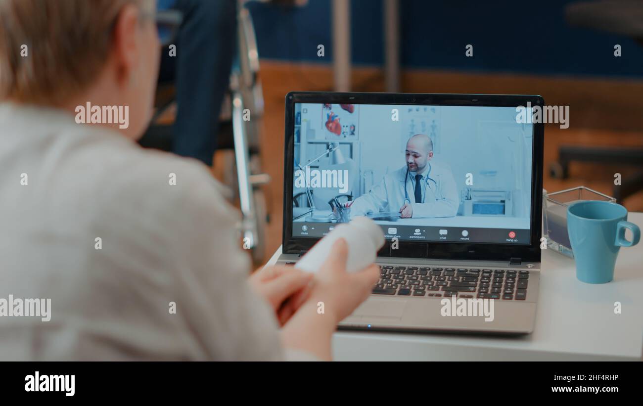 Retired woman attending medical consultation on videocall with doctor ...